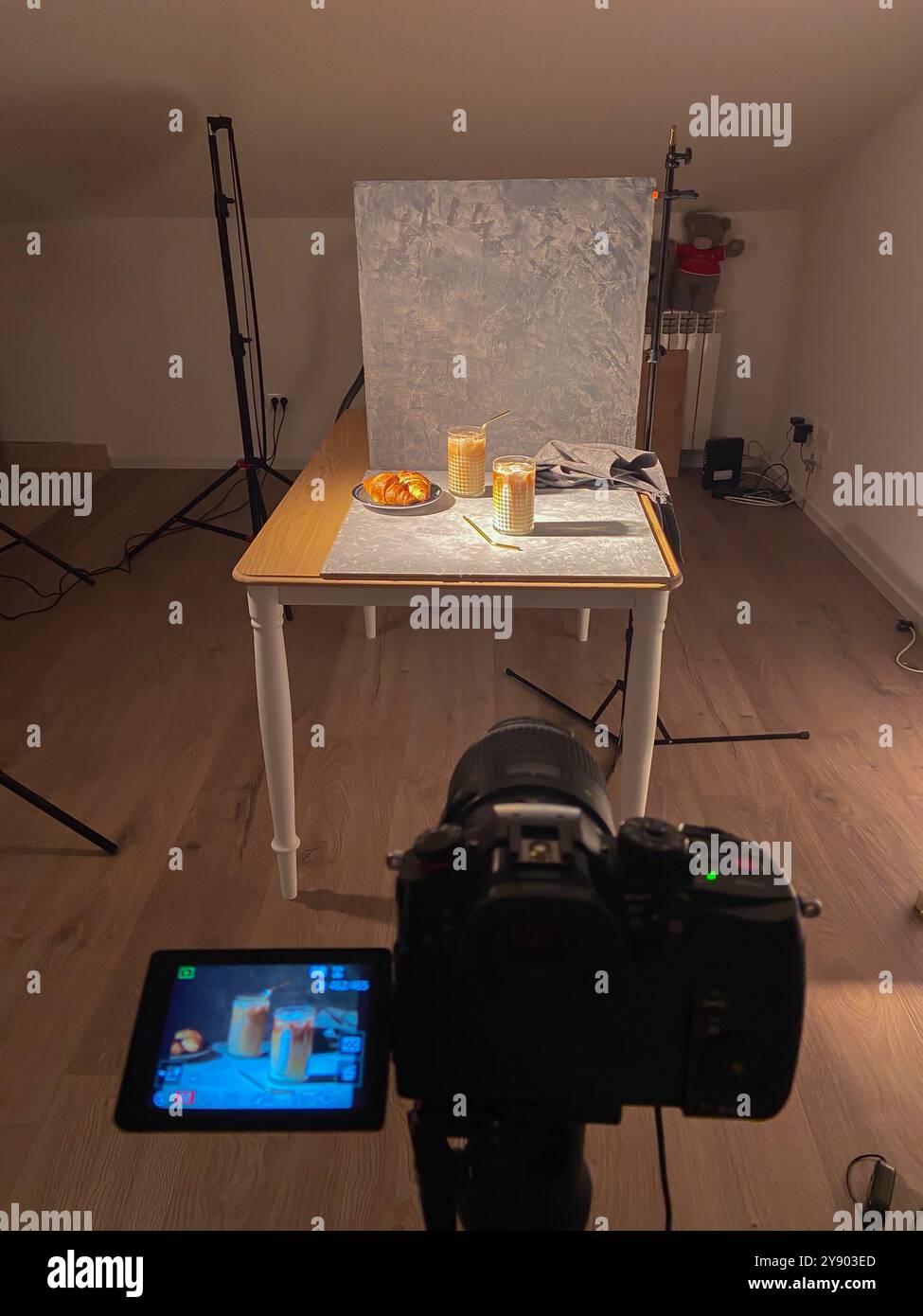 Camera setup captures a food photography scene with a cozy table ...