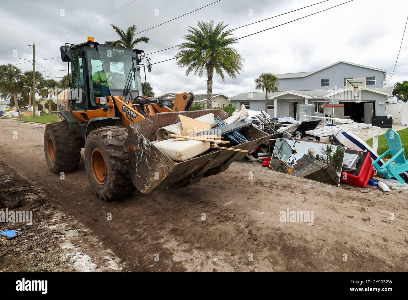 Contractors with the City of New Port Richey help clean debris left by ...