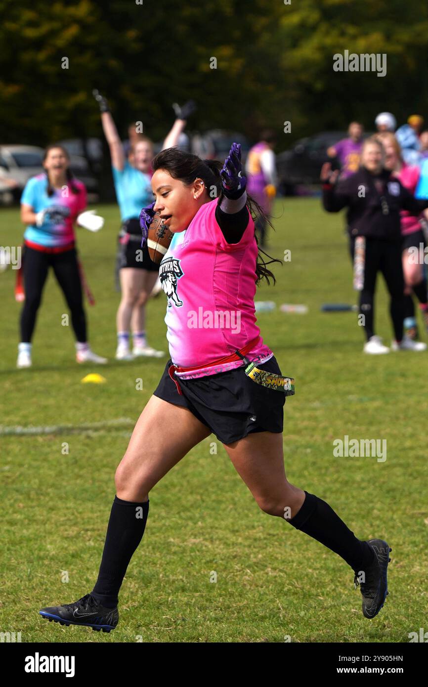 A hispanic female wide receiver celebrating a catch in the end zone at ...