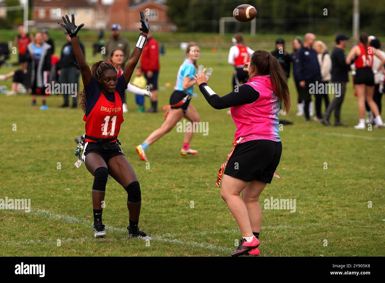 A black female defensive rusher putting pressure on the quarterback in ...
