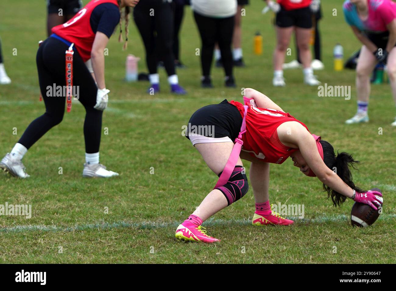 Female flag football player snapping the ball to start the play at ...