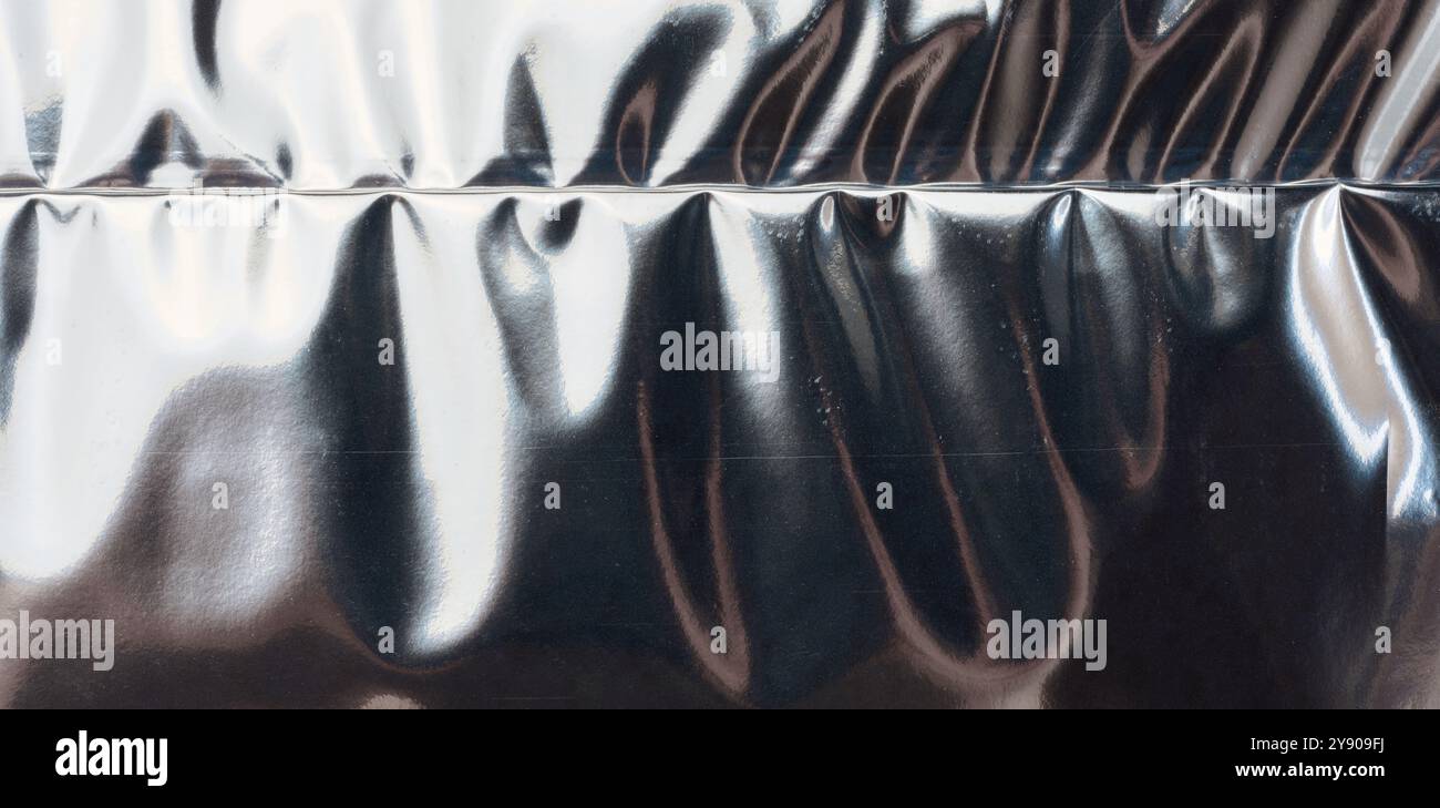 Crumpled sheet of gray foil, packaging material Stock Photo - Alamy