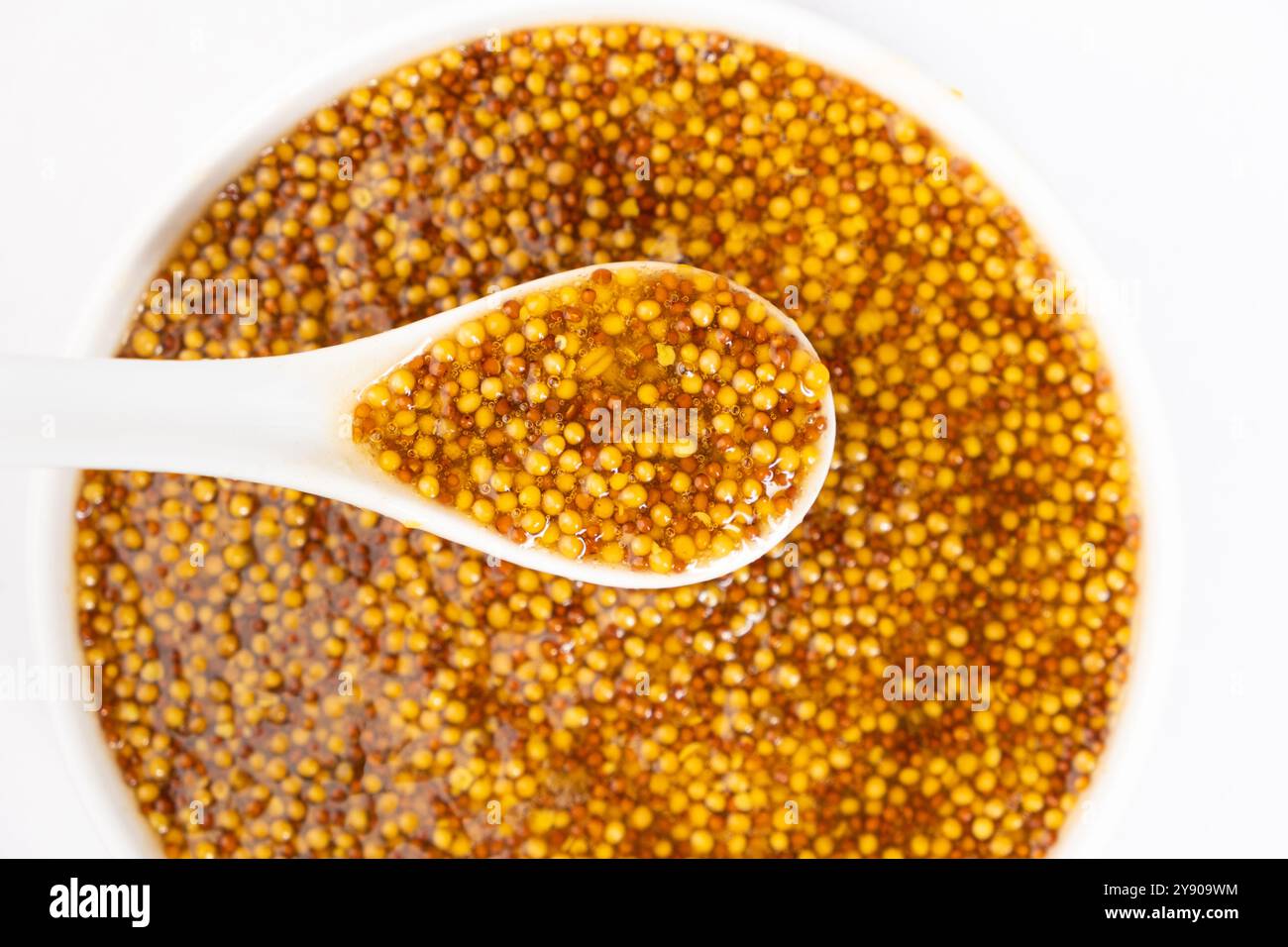 Traditional French Dijon mustard in a spoon on a white background Stock ...