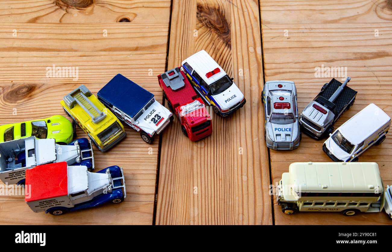 A collection of toy vehicles including police cars, ambulances, and ...