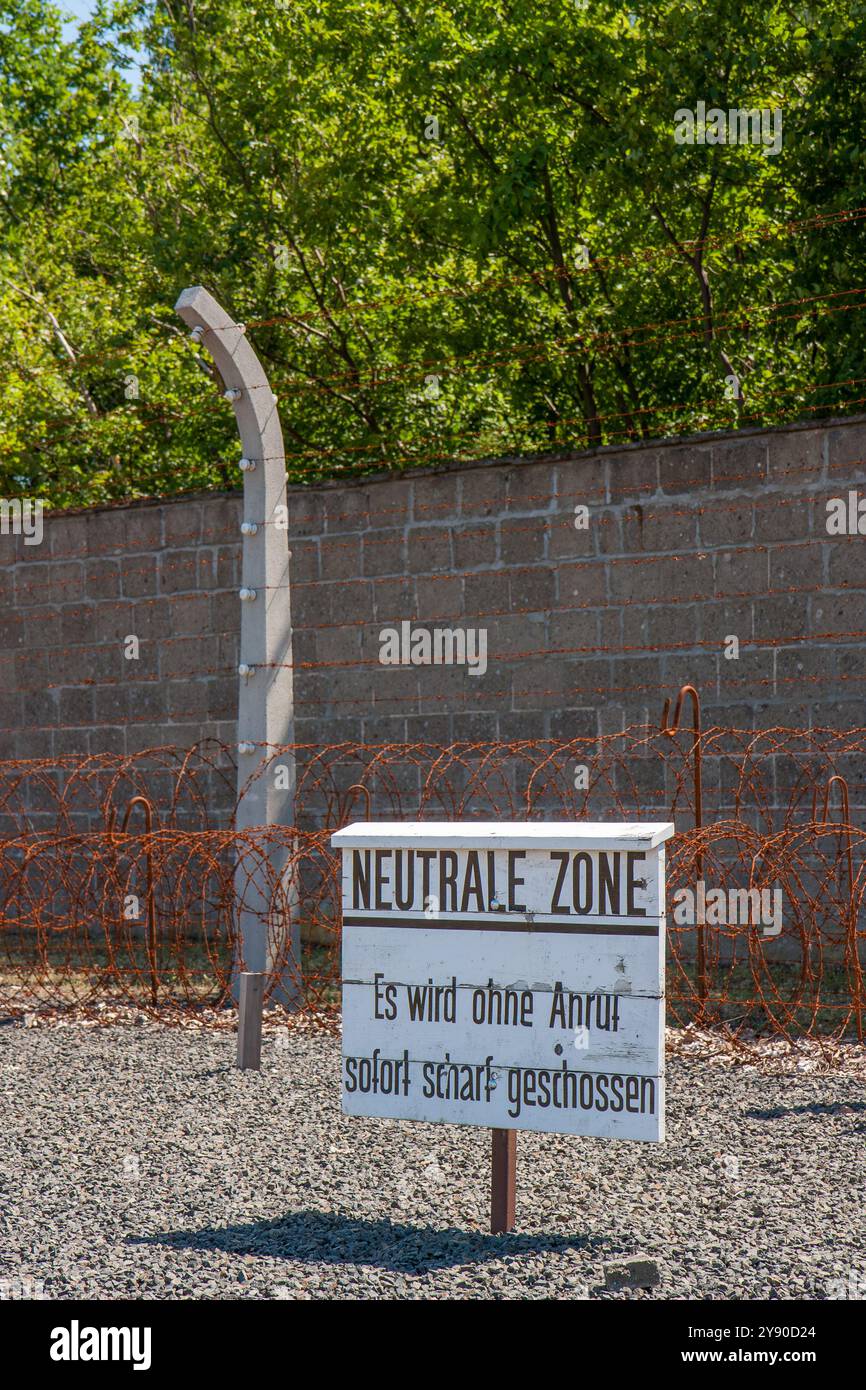 "Neutral zone. Immediate shooting without warning." Sign with barbed ...
