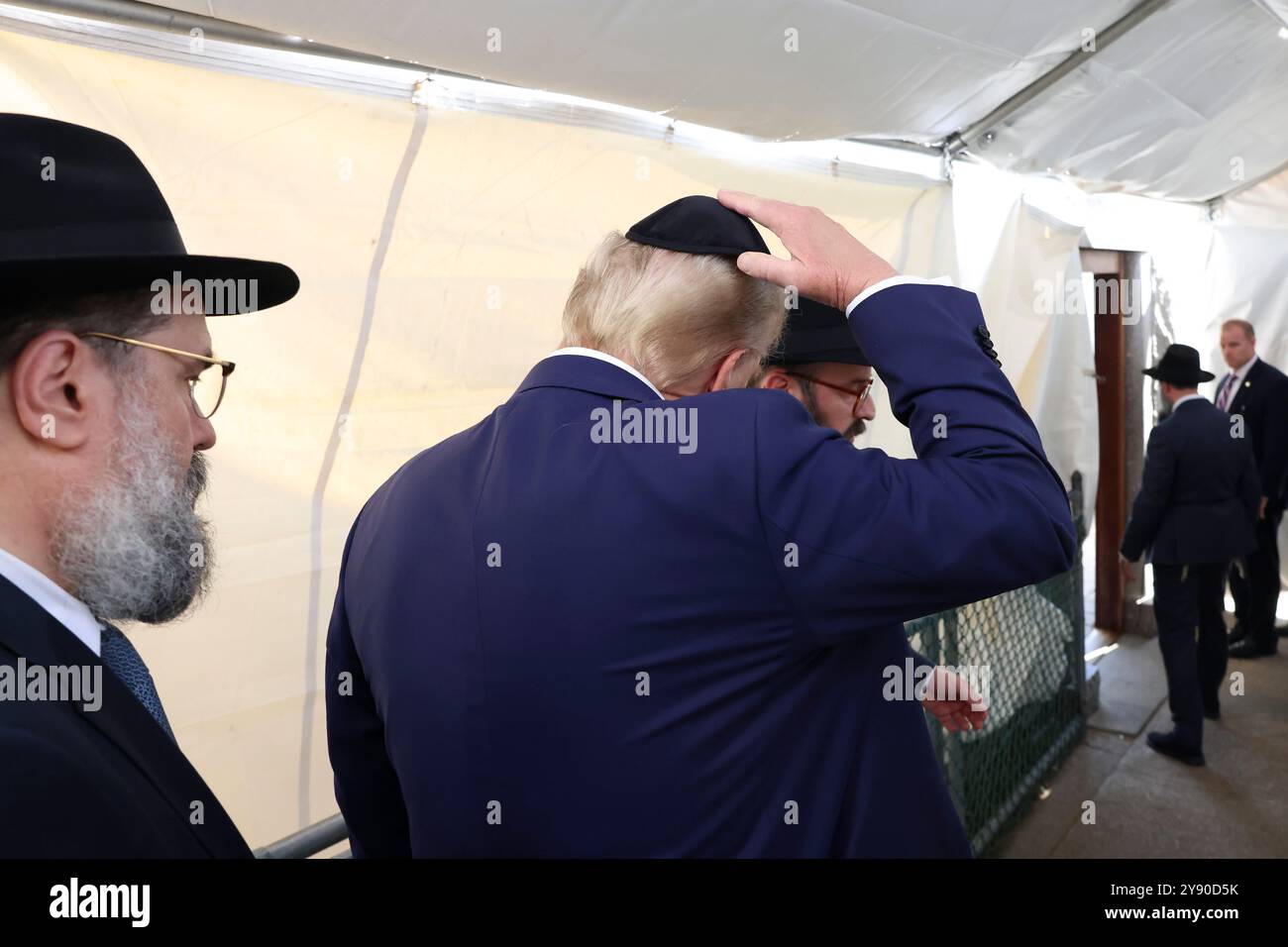 Republican presidential nominee former President Donald Trump puts on a ...