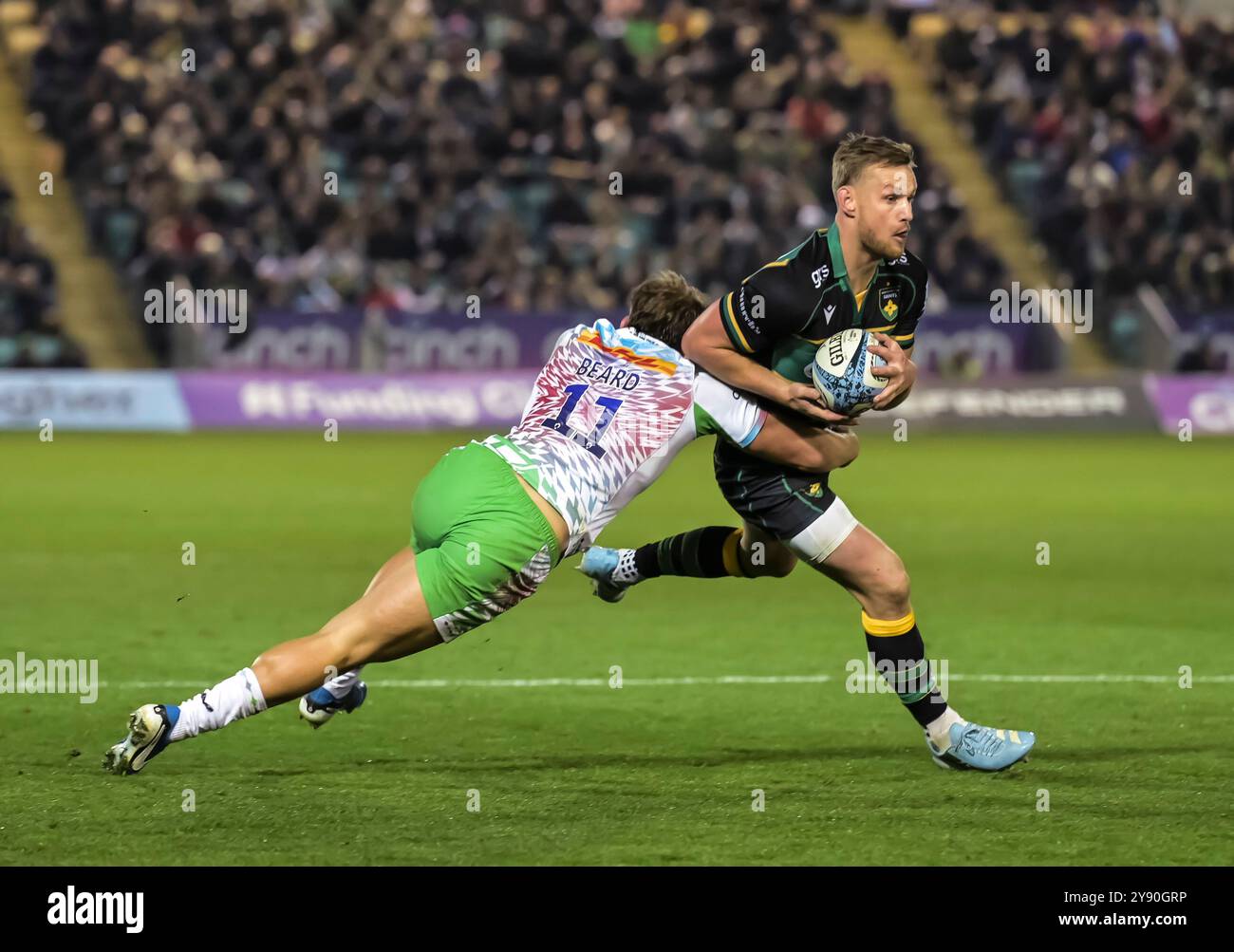 Oscar Beard of Harlequins tackles Rory Hutchinson of Northampton Saints ...