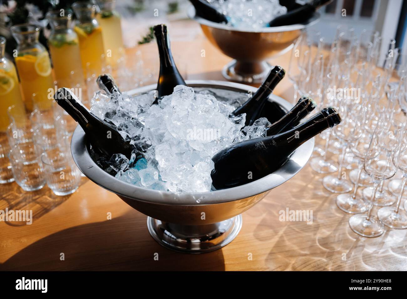 Chilled champagne bottles in ice bucket with lemonade pitchers and ...