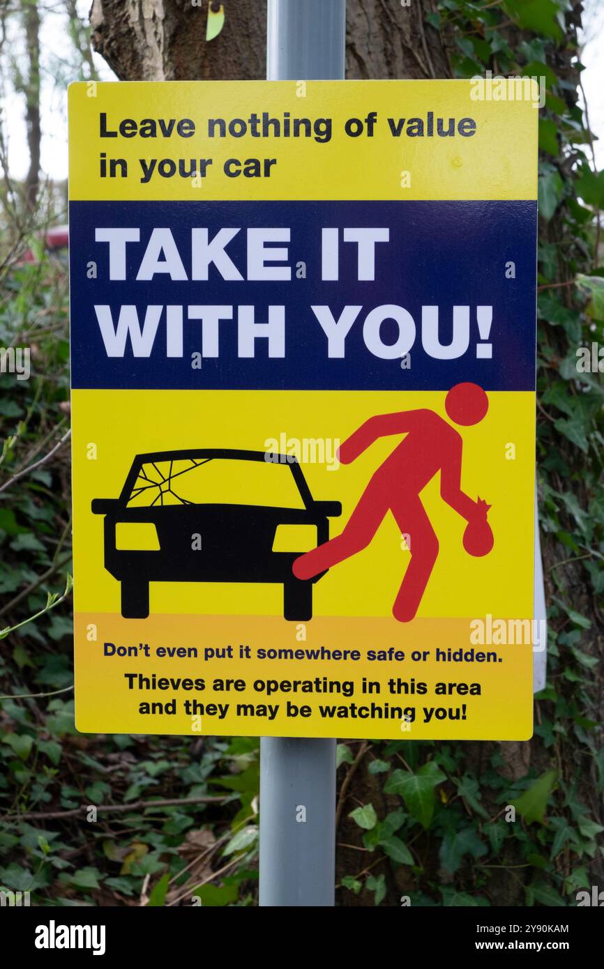 Take it with you theft warning sign in a car park Stock Photo - Alamy