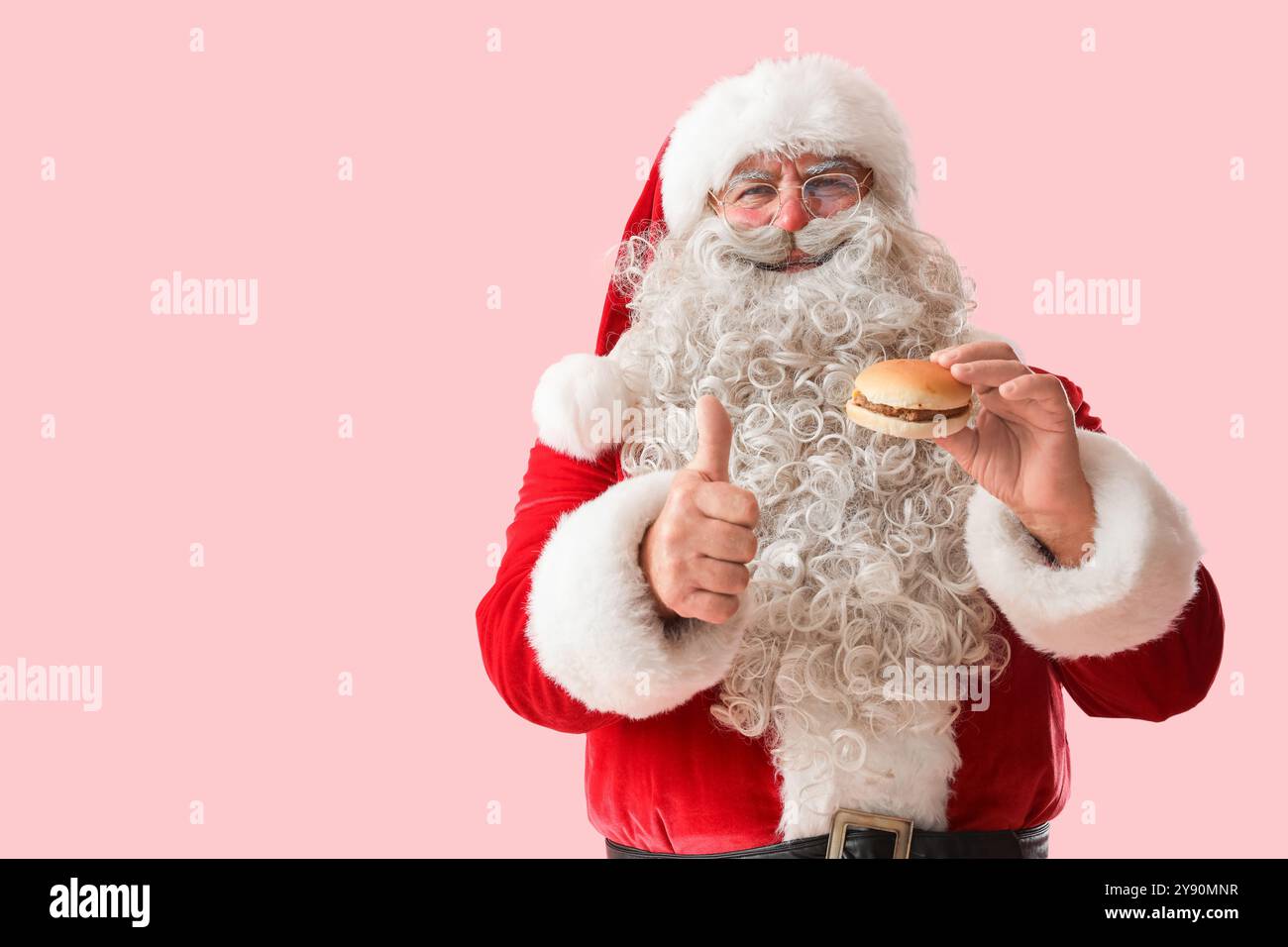 Santa Claus with tasty burger showing thumb-up on pink background Stock ...