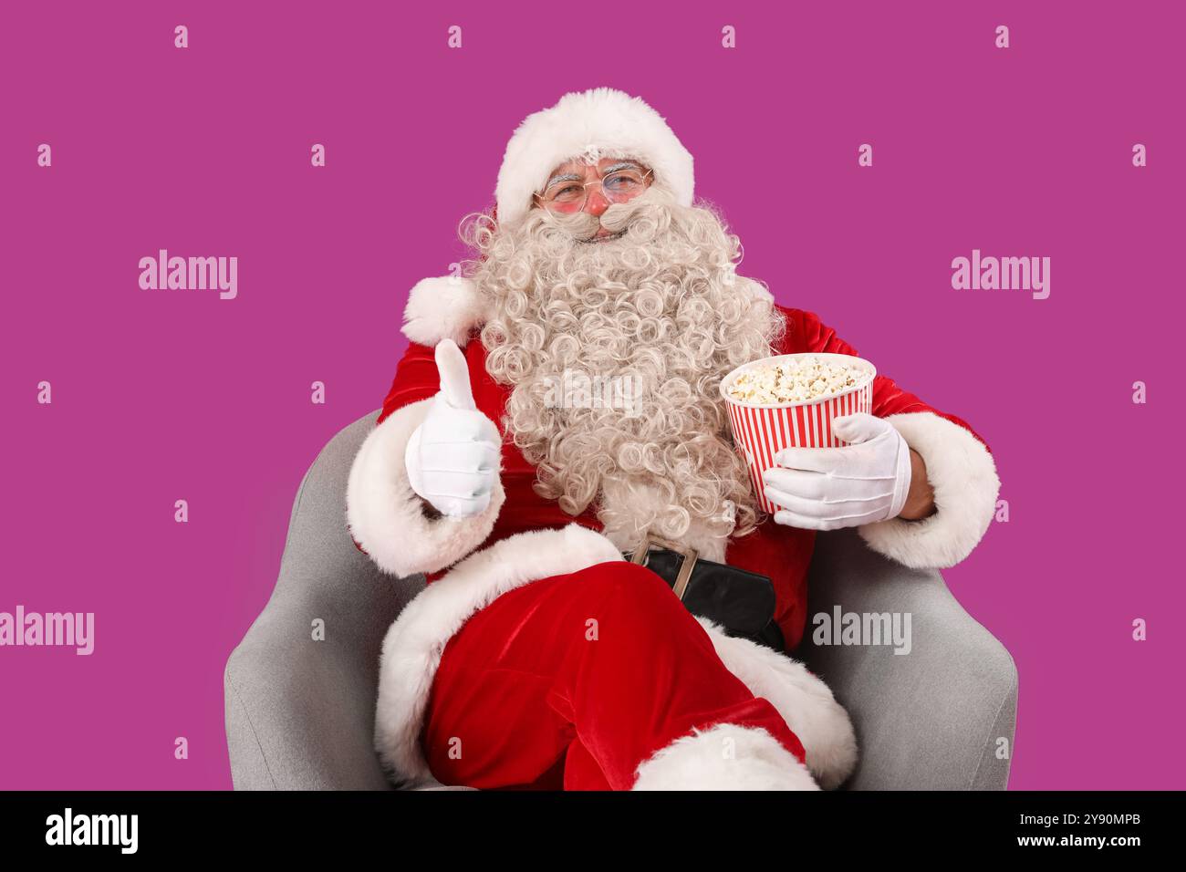 Santa Claus with tasty popcorn showing thumb-up on purple background ...