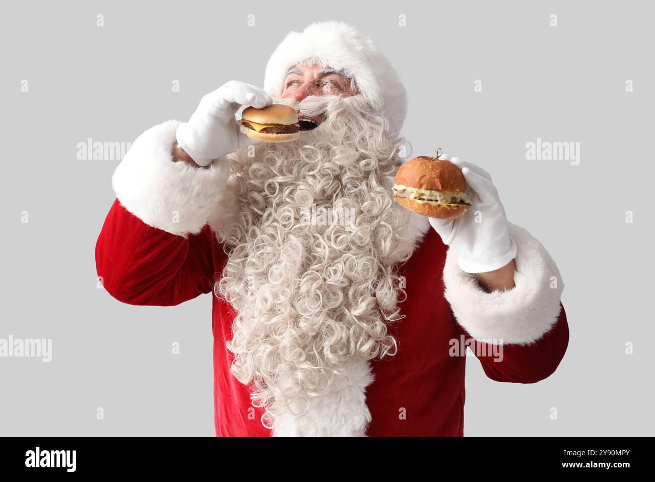 Santa Claus with tasty burgers on white background Stock Photo - Alamy