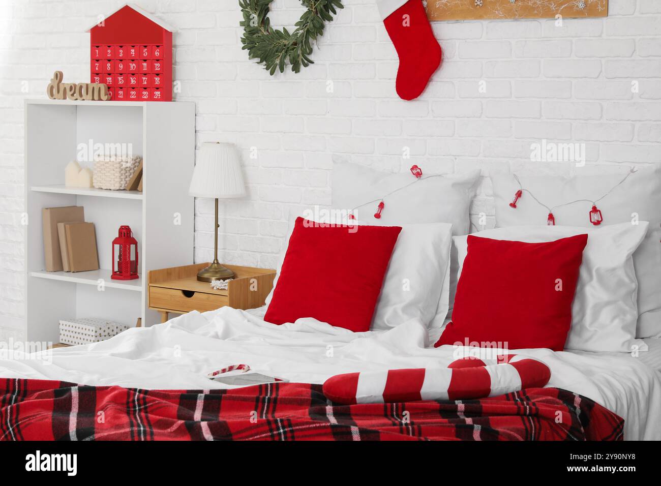 Festive bedroom with cozy bed, candy canes and Christmas decorations ...