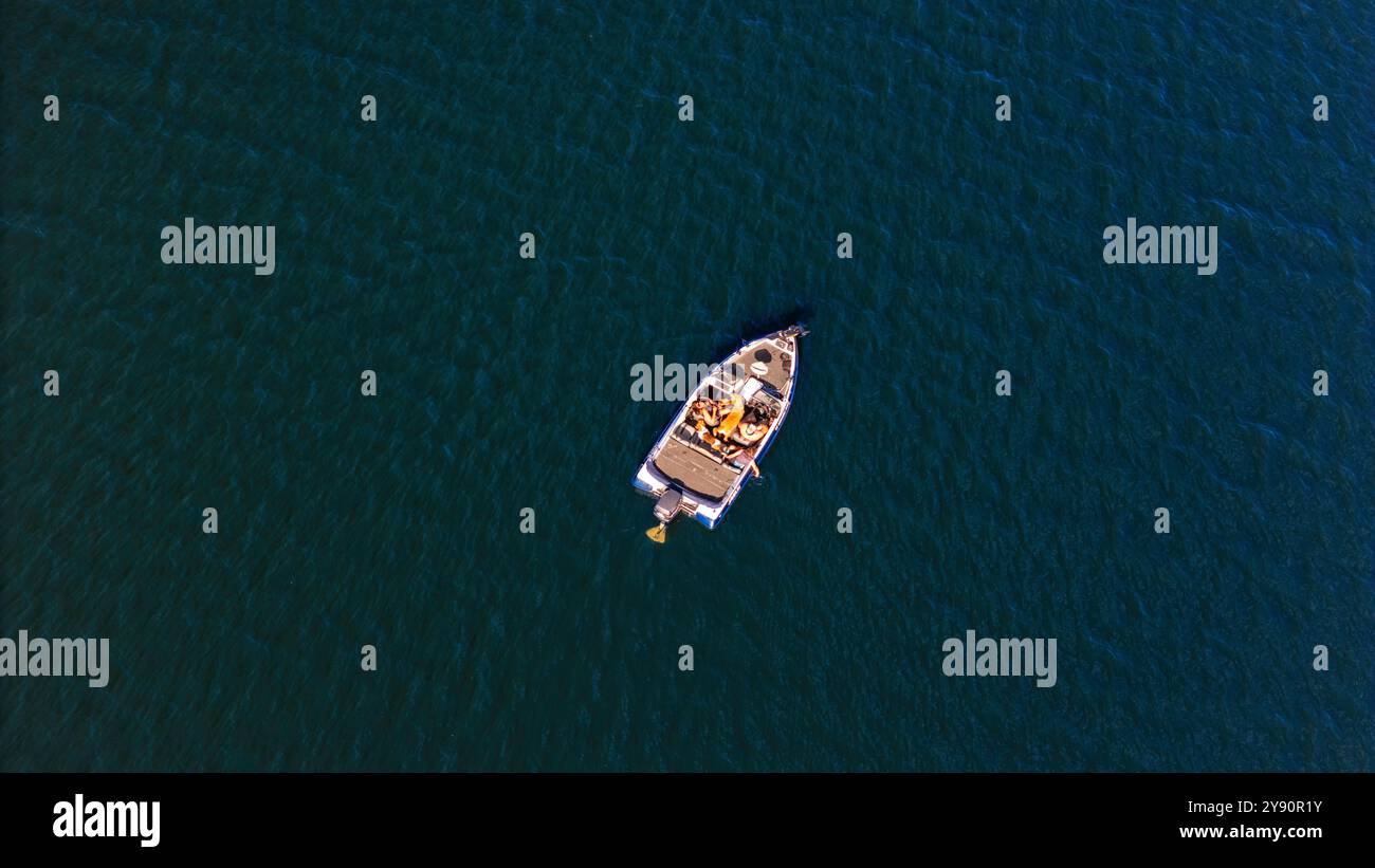 Aerial photograph of three people in a motor boat on Bear Lake, Barron ...