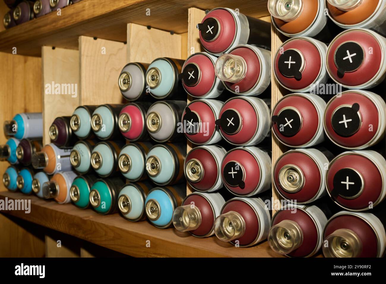 Part of long wooden shelf with several square cells containing stacks ...