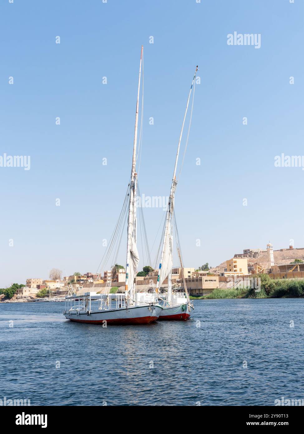 Traditional Egyptian felucca boat sailing down the great Nile River in ...