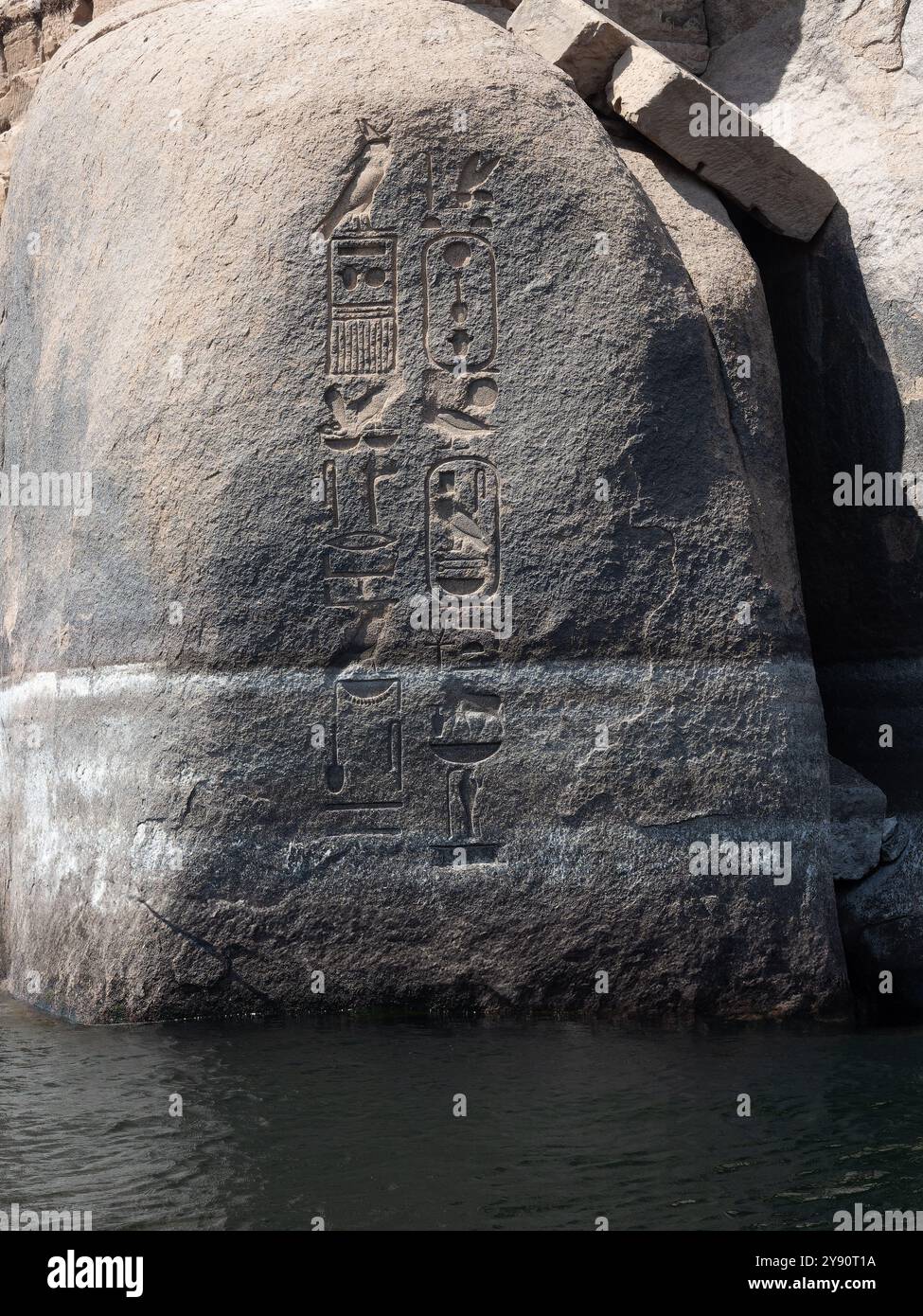 Egyptian hieroglyphic engravings on the walls of a stone in the Nile ...