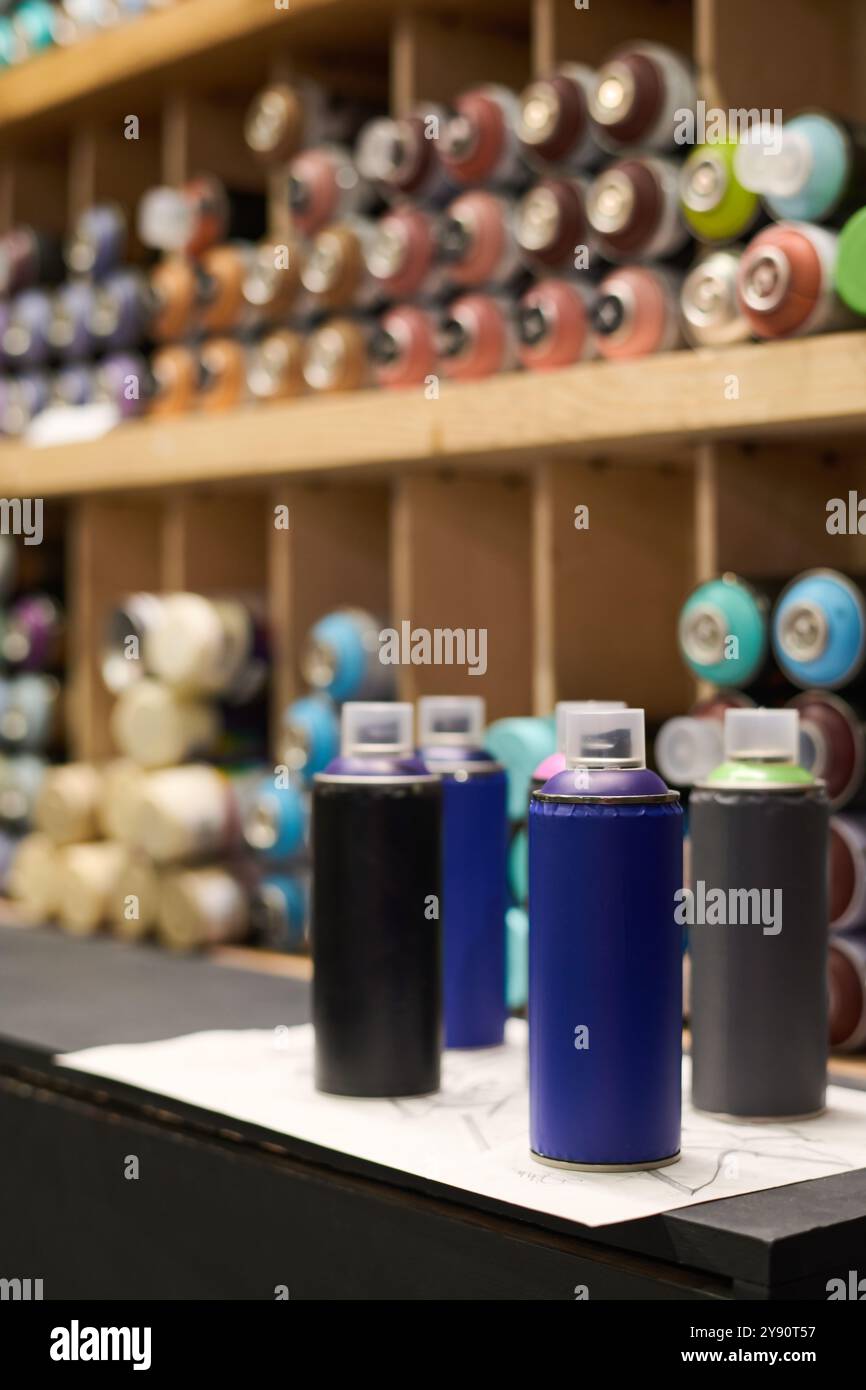 Four unopened dispensers with graffiti paints of different colors ...