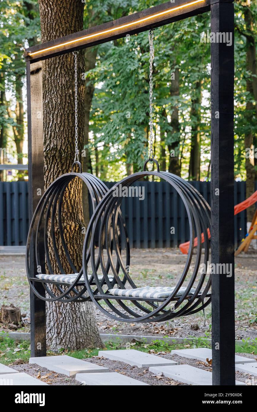 Modern hanging round swings hi-res stock photography and images - Alamy