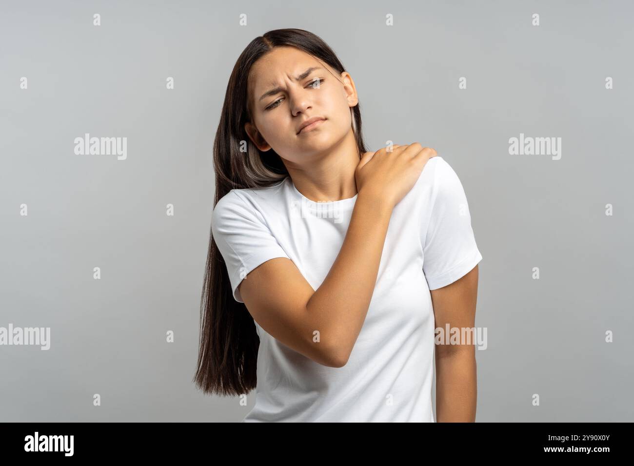 Frowing sad teen girl discomfort, stretch neck muscles from poor ...
