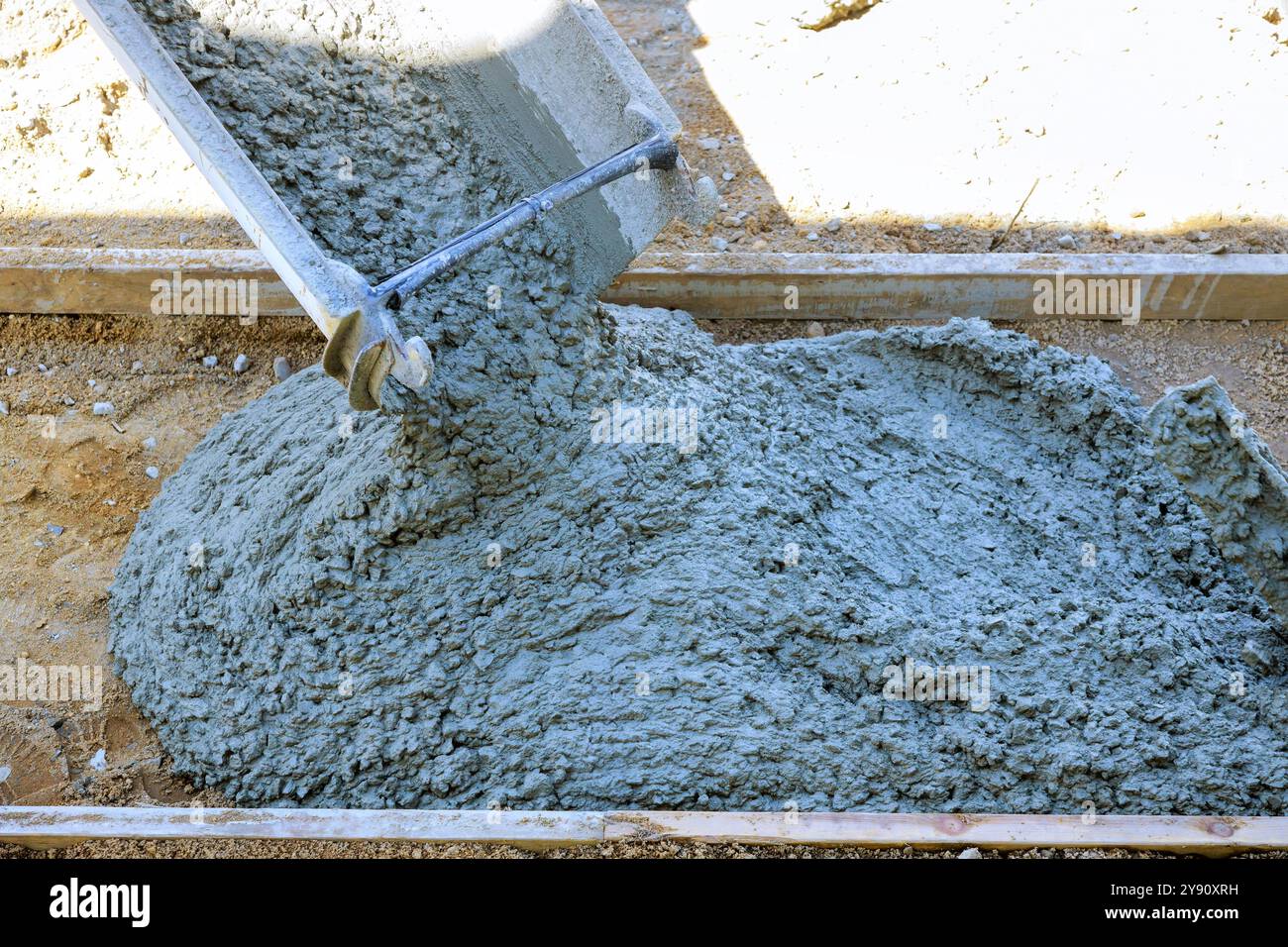 Concrete mixer truck pours fresh concrete over reinforced bars for ...