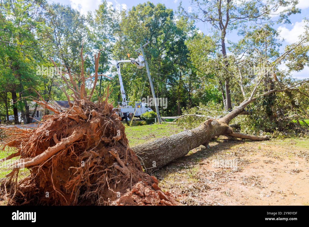 An emergency crew is working to restore power following severe damage caused by violent ...