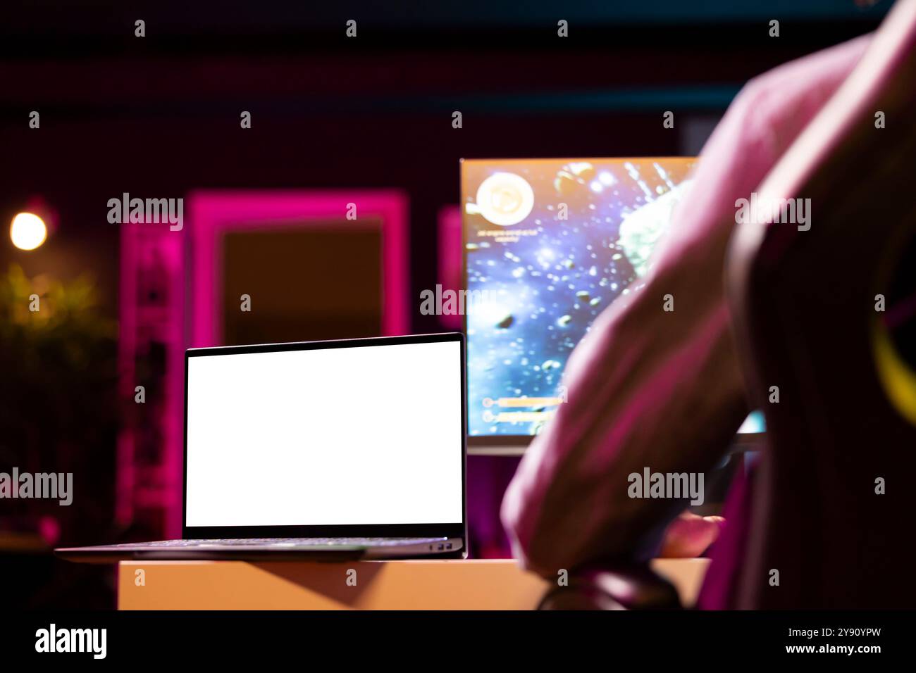 Mockup laptop next to man playing high FPS singleplayer videogame with ...
