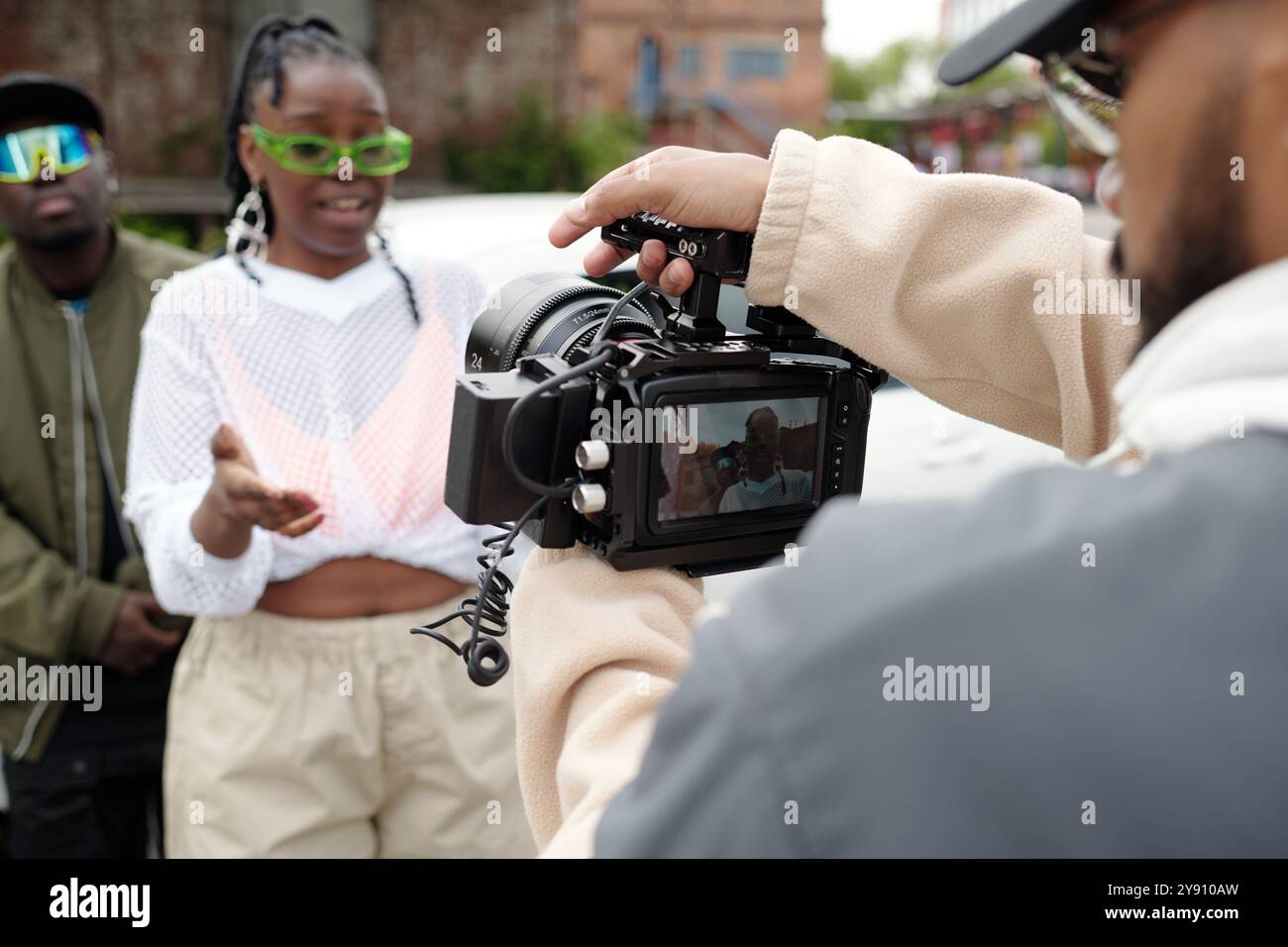 Person filming a street interview with modern camera equipment ...