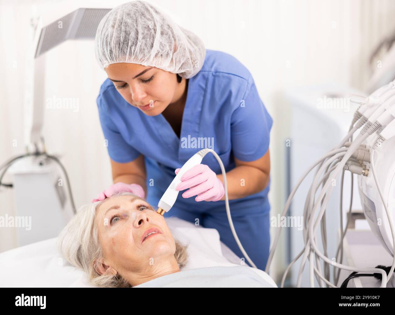 Old woman having face radiolifting procedure Stock Photo - Alamy