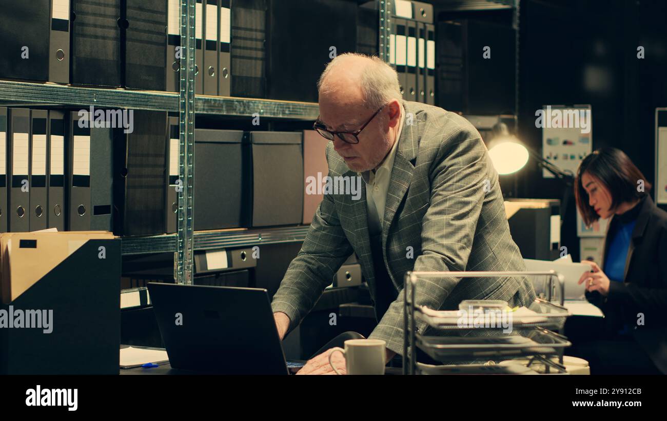 Senior private agent working on criminal report with classified data ...