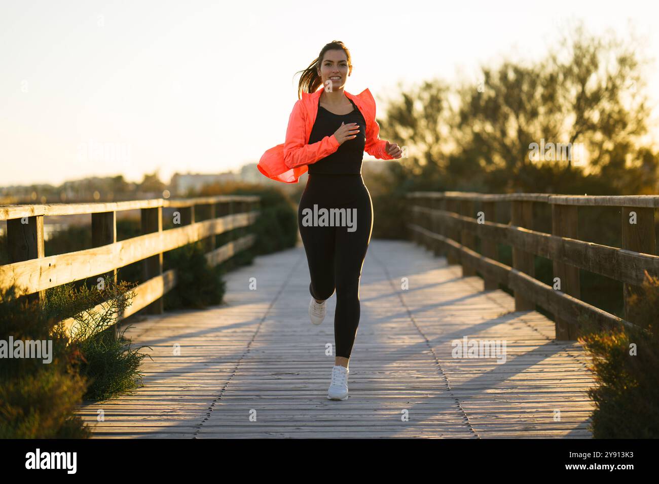 An Energetic Woman is Running in Nature During the Beautiful Sunrise ...