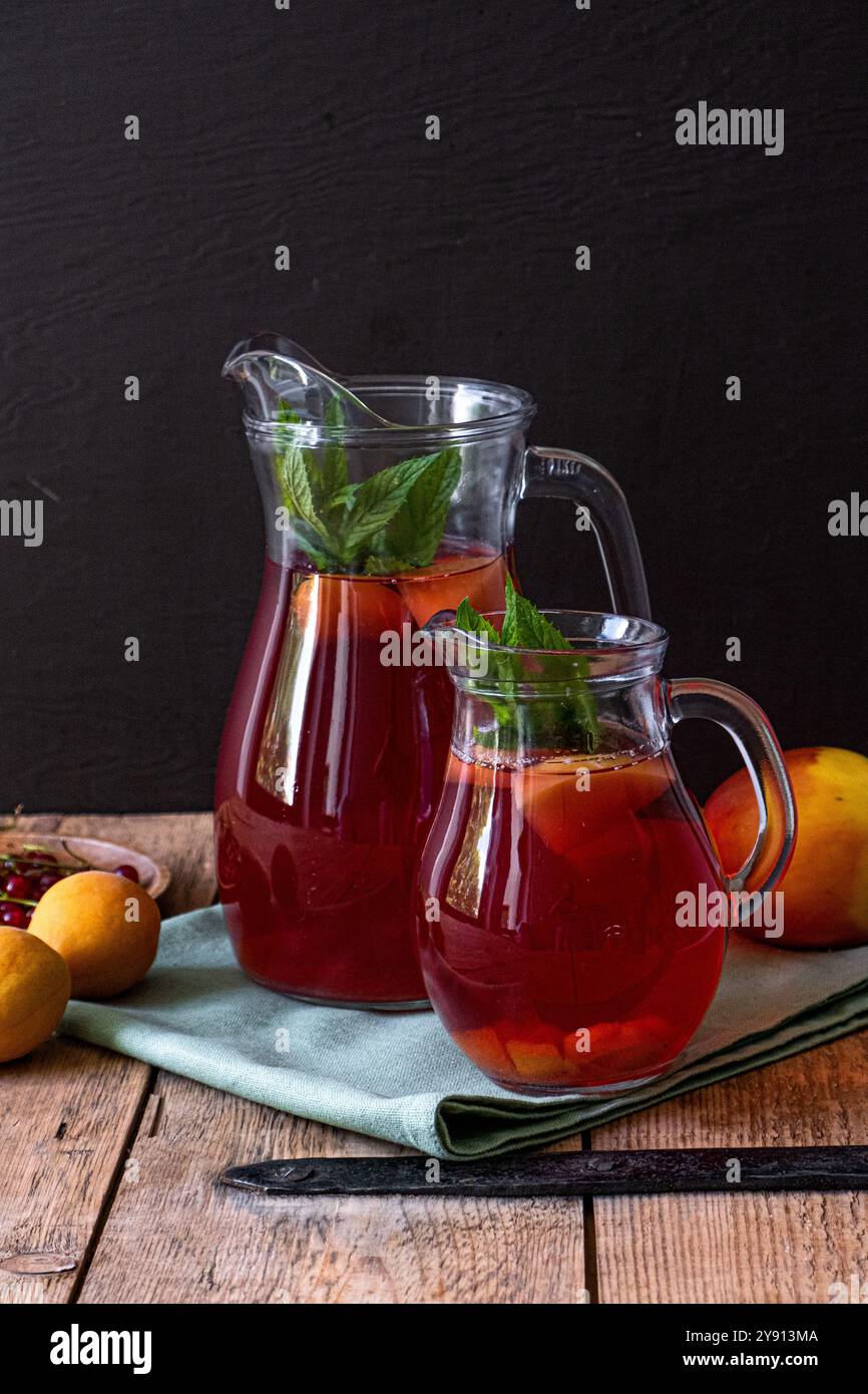 Drink with fruits in a jug. Berry compote. Refreshing drinks for summer ...