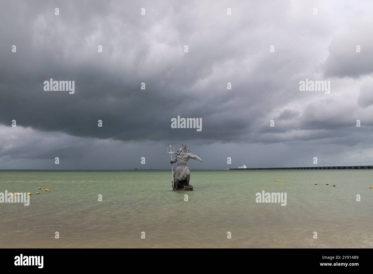 A sculpture of Poseidon stands in the ocean before the arrival of ...