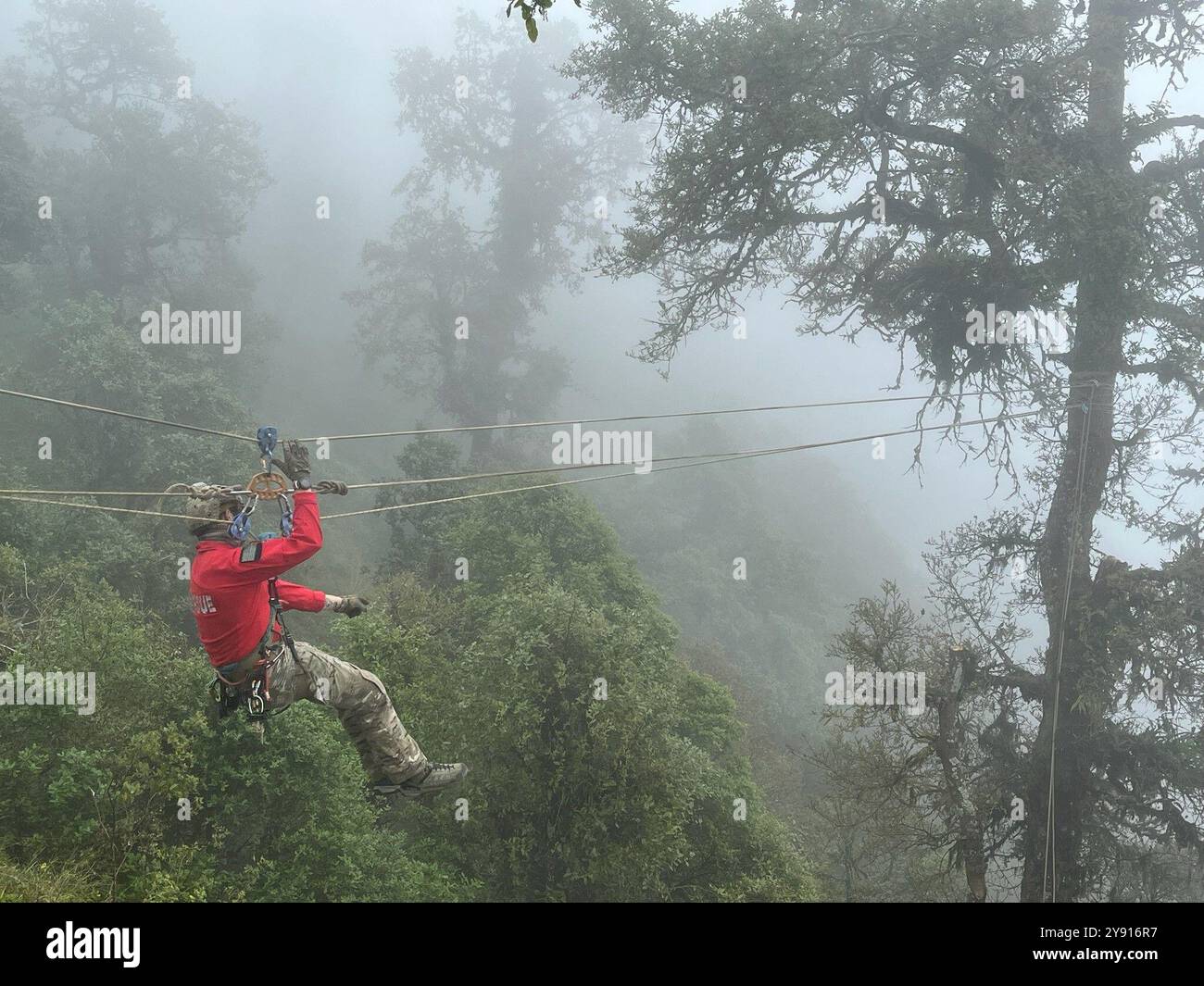 A U.S. Air Force Guardian Angel demonstrates high angle rescue training ...