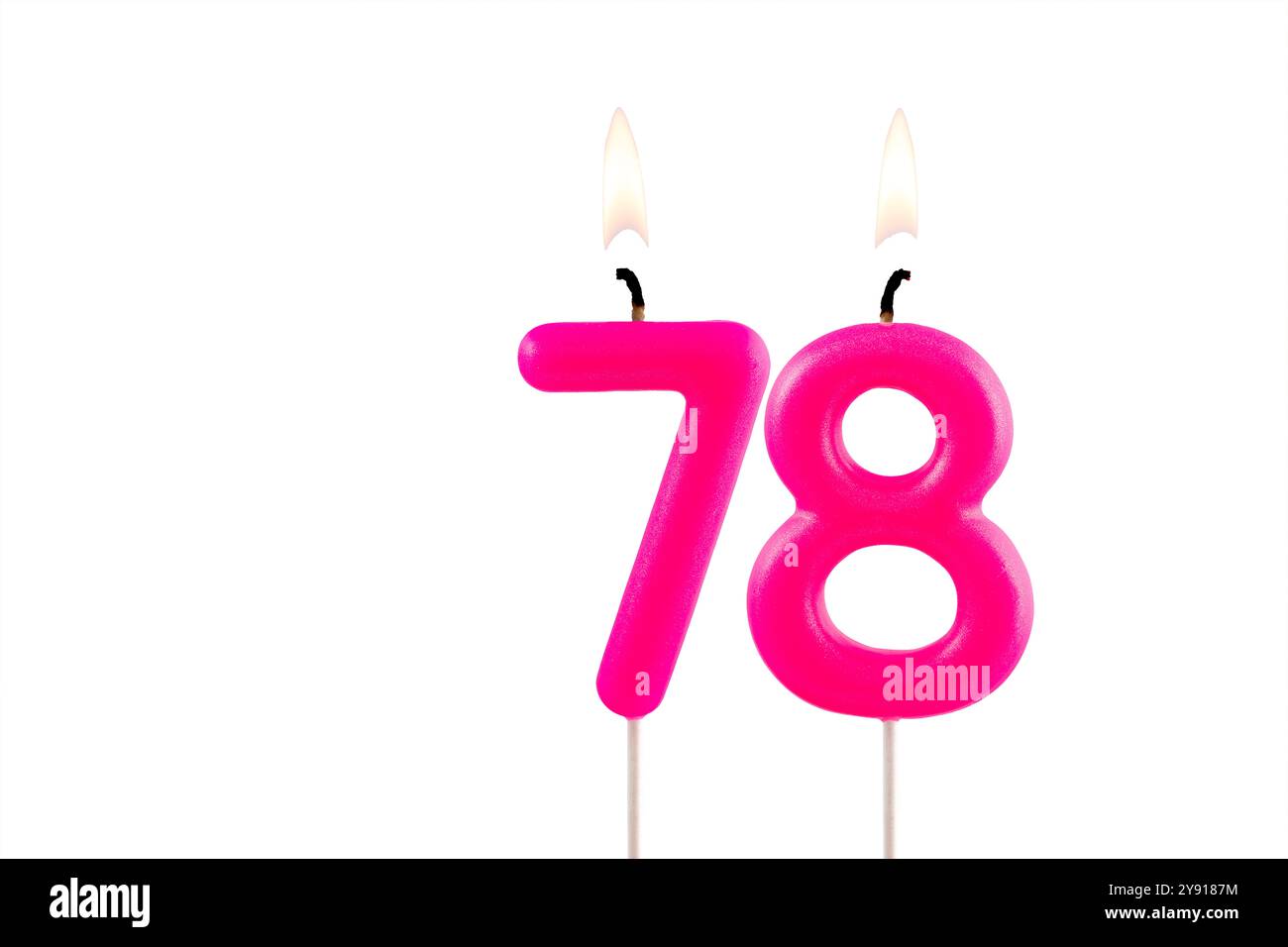Pink number 78 birthday candle lit on white background Stock Photo - Alamy