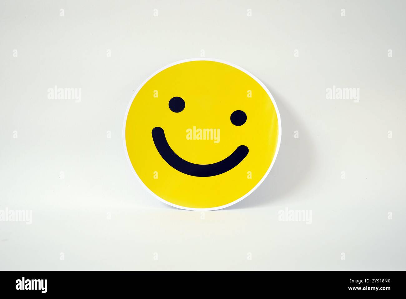 Yellow smiley face sticker. A smiling face is a symbol of happiness and ...
