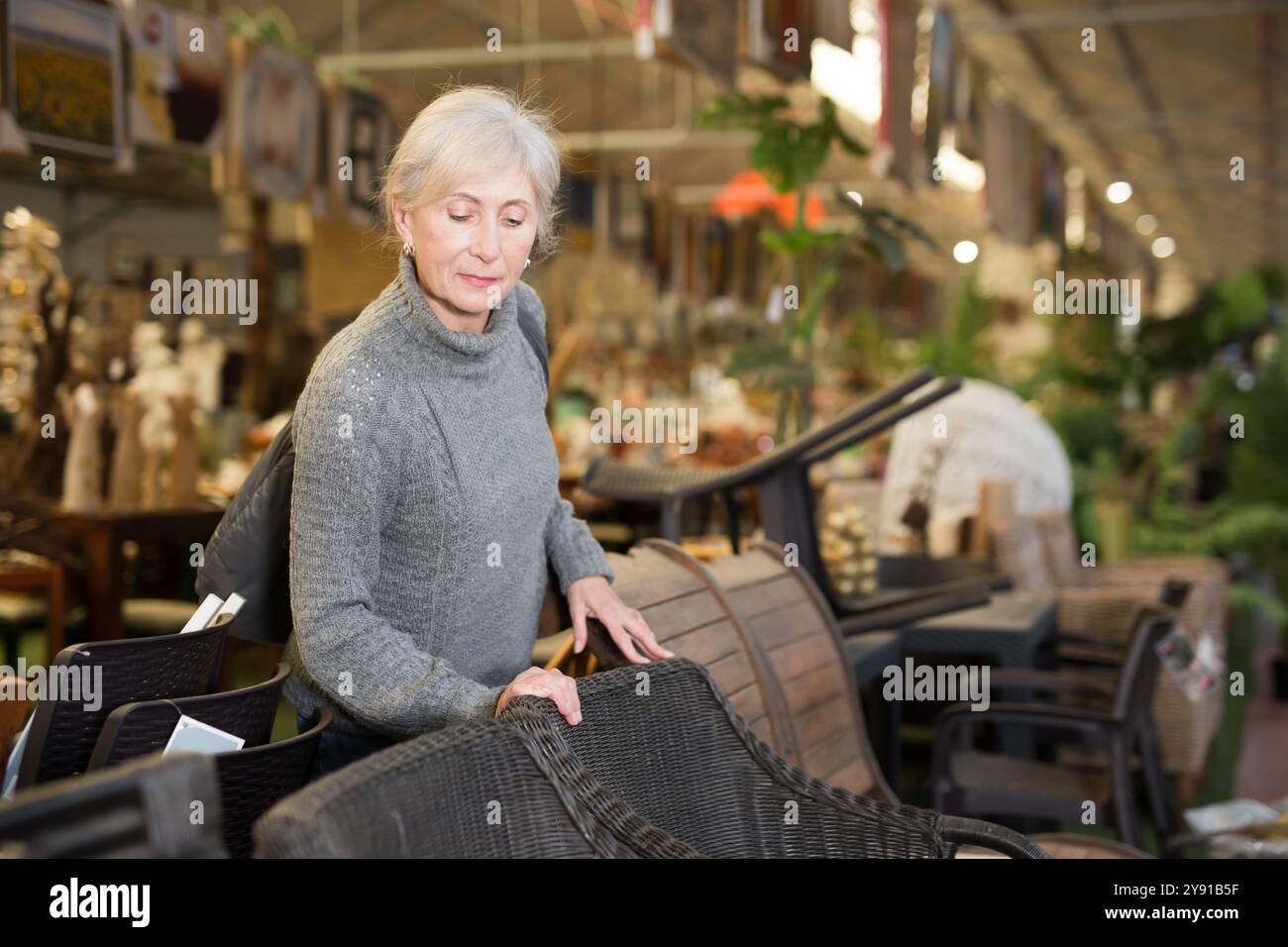 Senior woman shopping in furniture store Stock Photo - Alamy