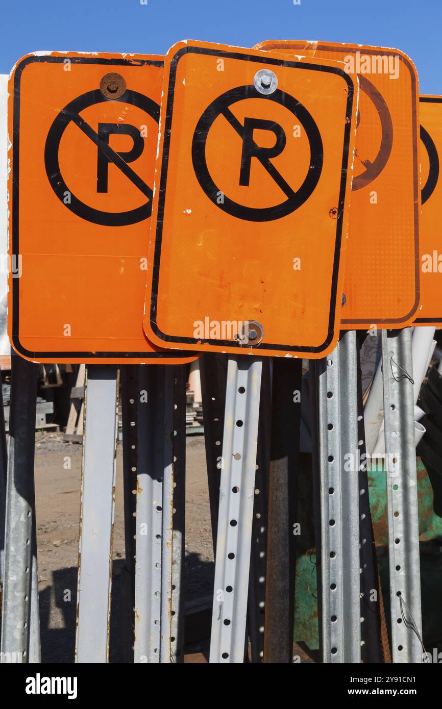 Close-up of fluorescent orange and black No Parking mobile street signs ...