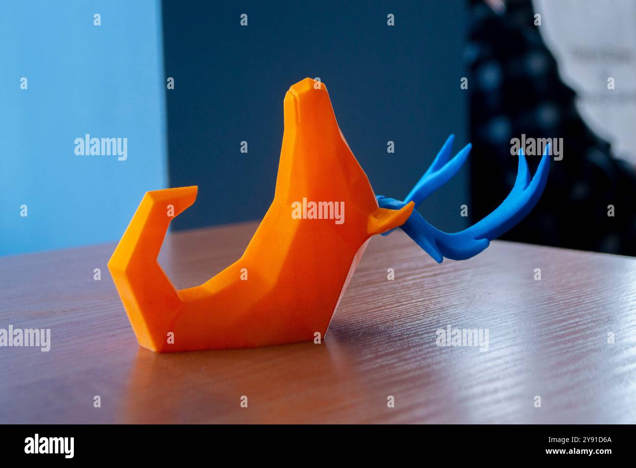 Art object printed on 3D printer. Abstract toy model orange deer with ...