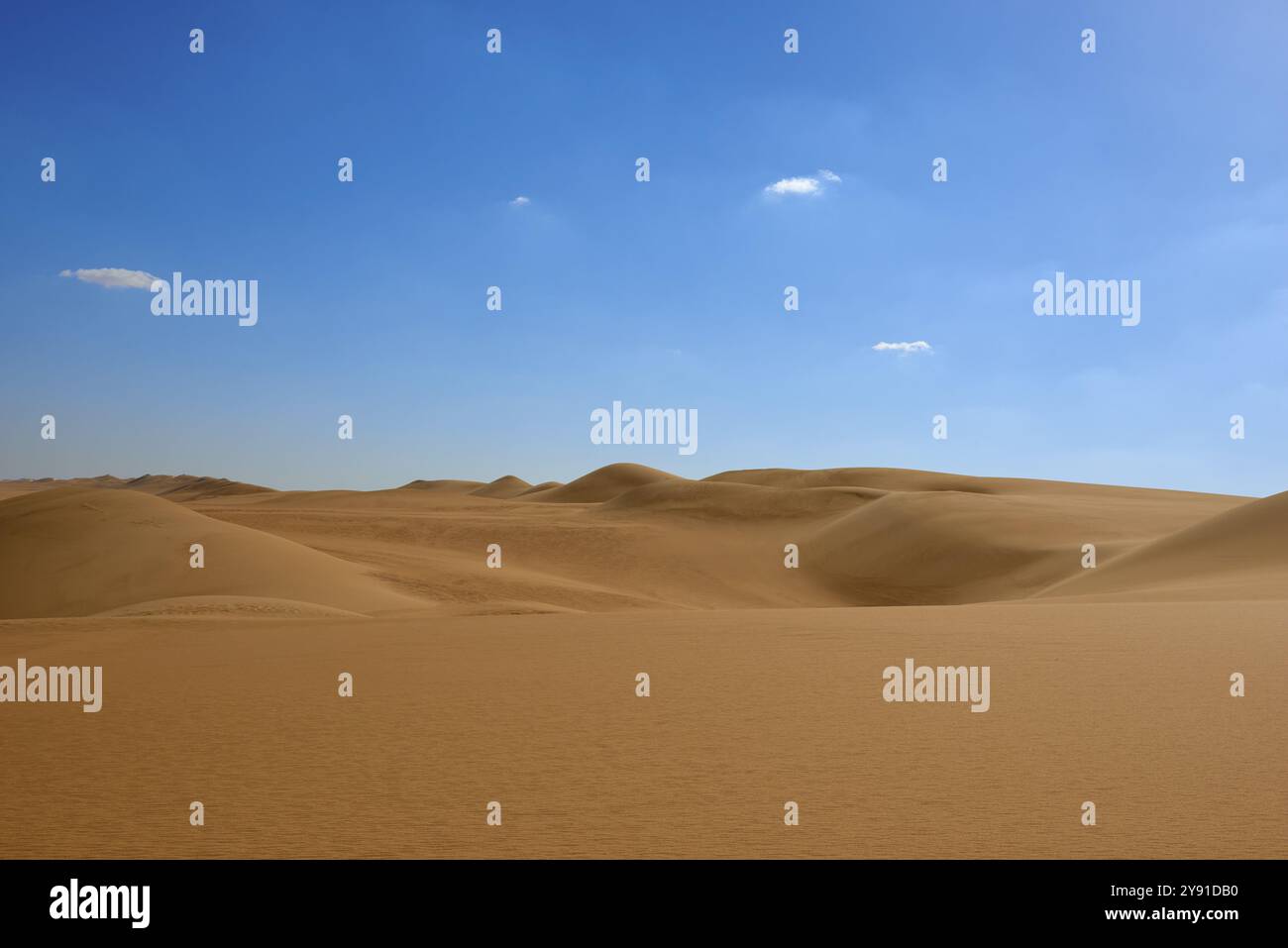 Endless sand dunes under a clear blue sky with few clouds, Matruh ...