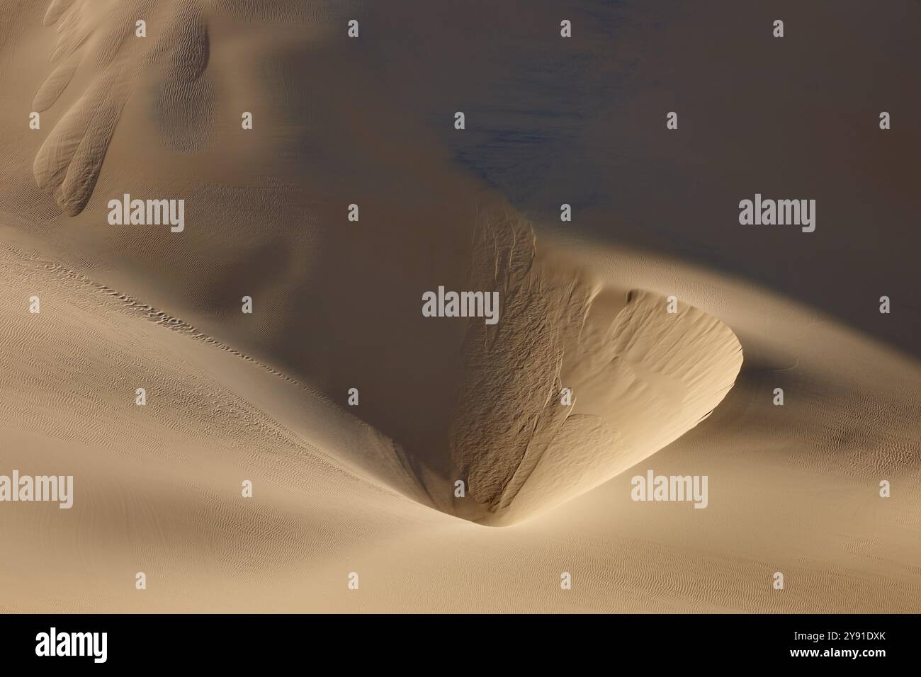 Gentle sand dunes under a clear blue sky with playful shadows, Matruh ...