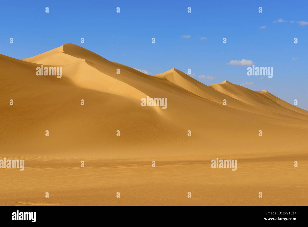 Endless sand dunes under a clear blue sky with few clouds, Matruh ...