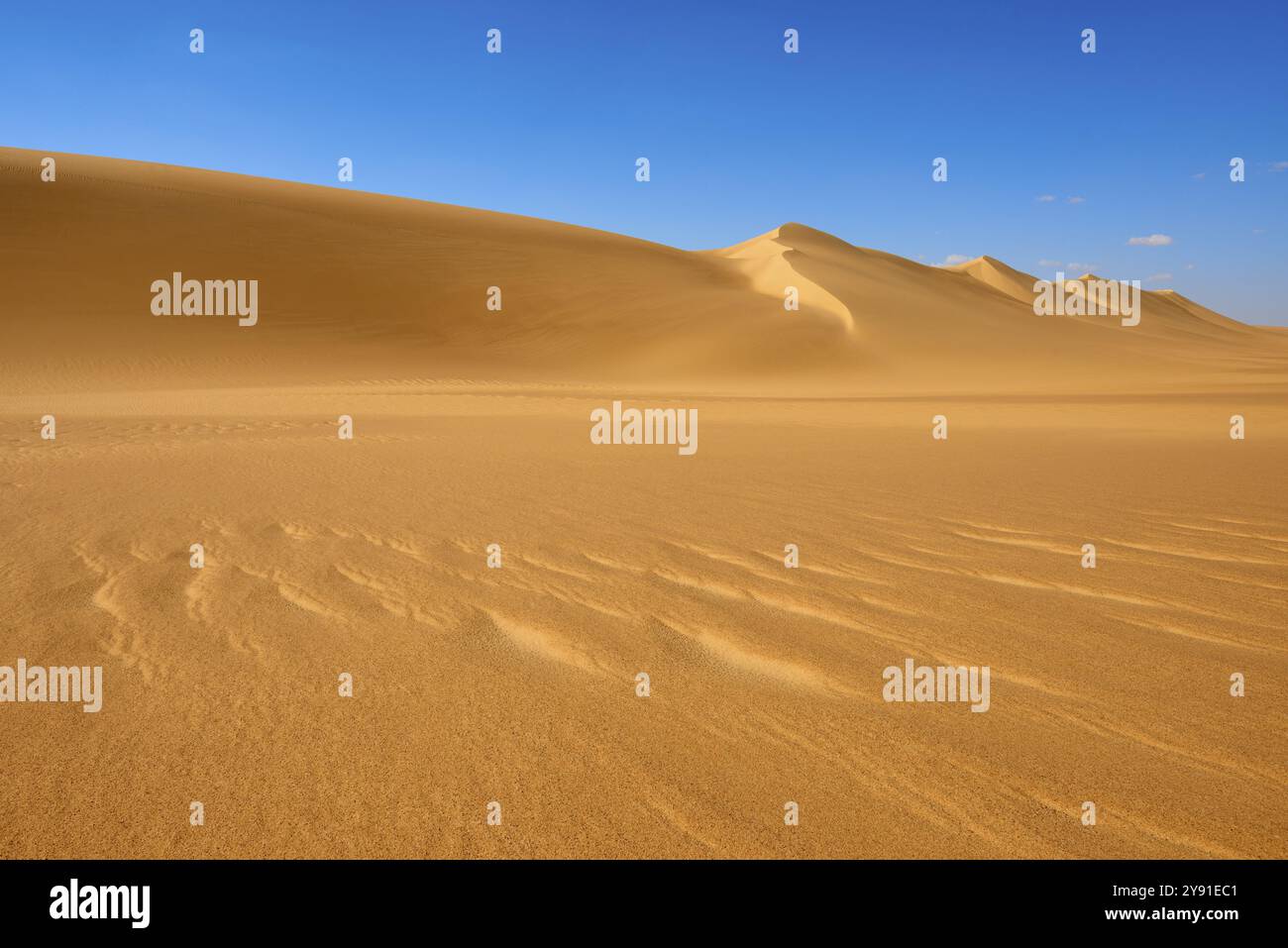 Endless sand dunes under a clear blue sky with few clouds, Matruh ...