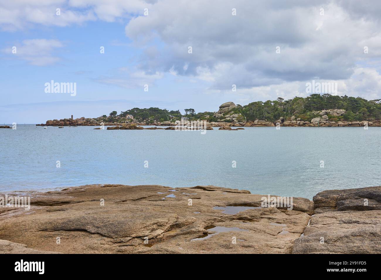 Round granite rocks with a view of the offshore island with the Chateau ...