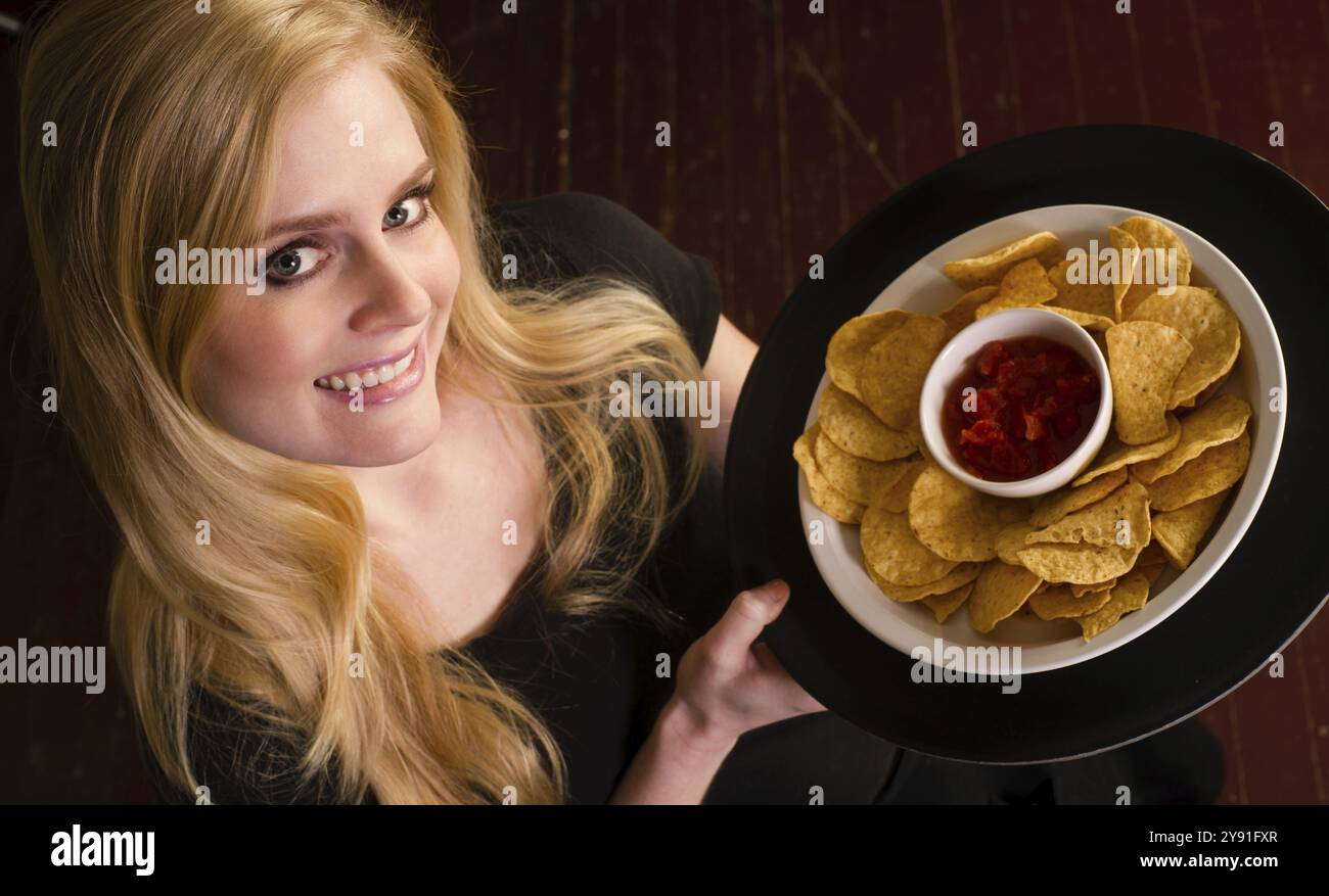 Vibrant service professional brings the servings Stock Photo - Alamy