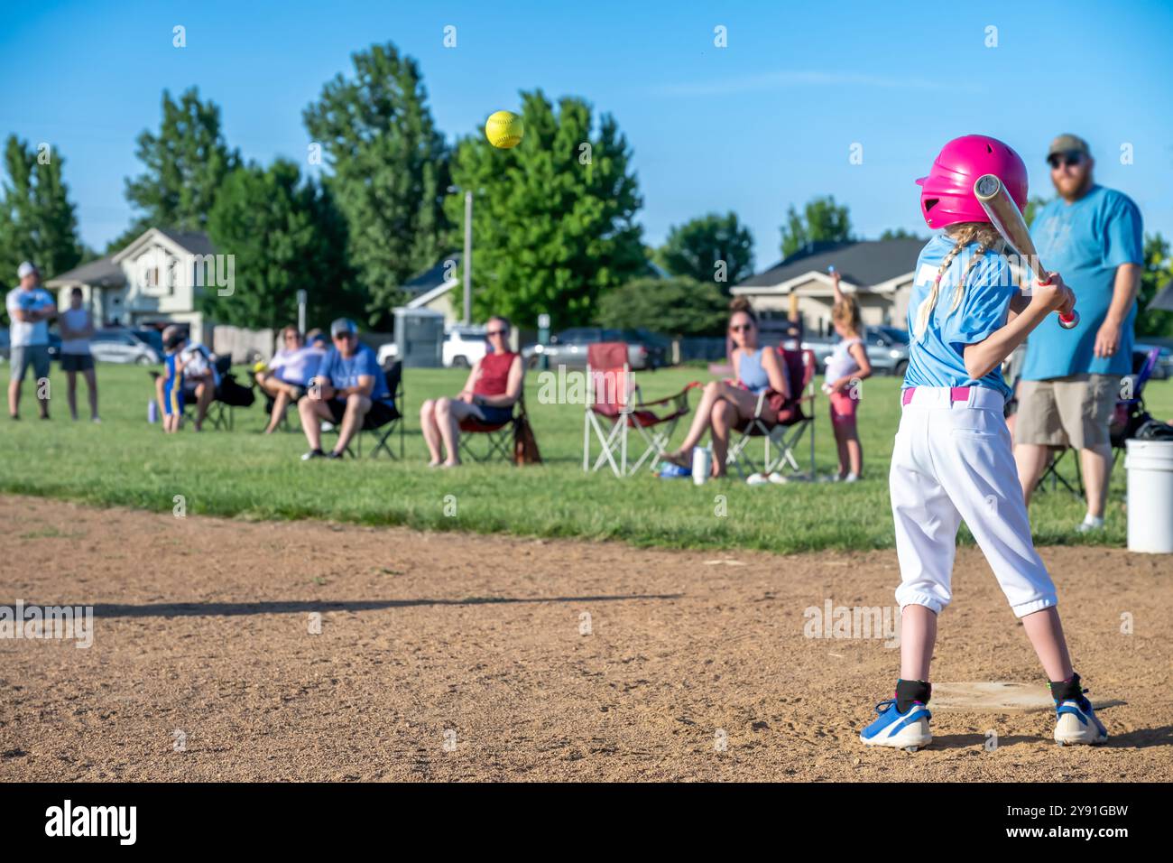 Youth girl softball player at bat during a game Stock Photo - Alamy