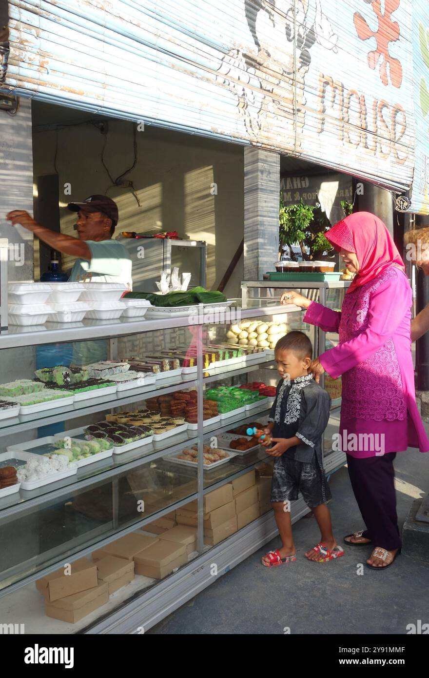 Child choosing sweets from confectionery shop, Gorontalo, Sulawesi ...