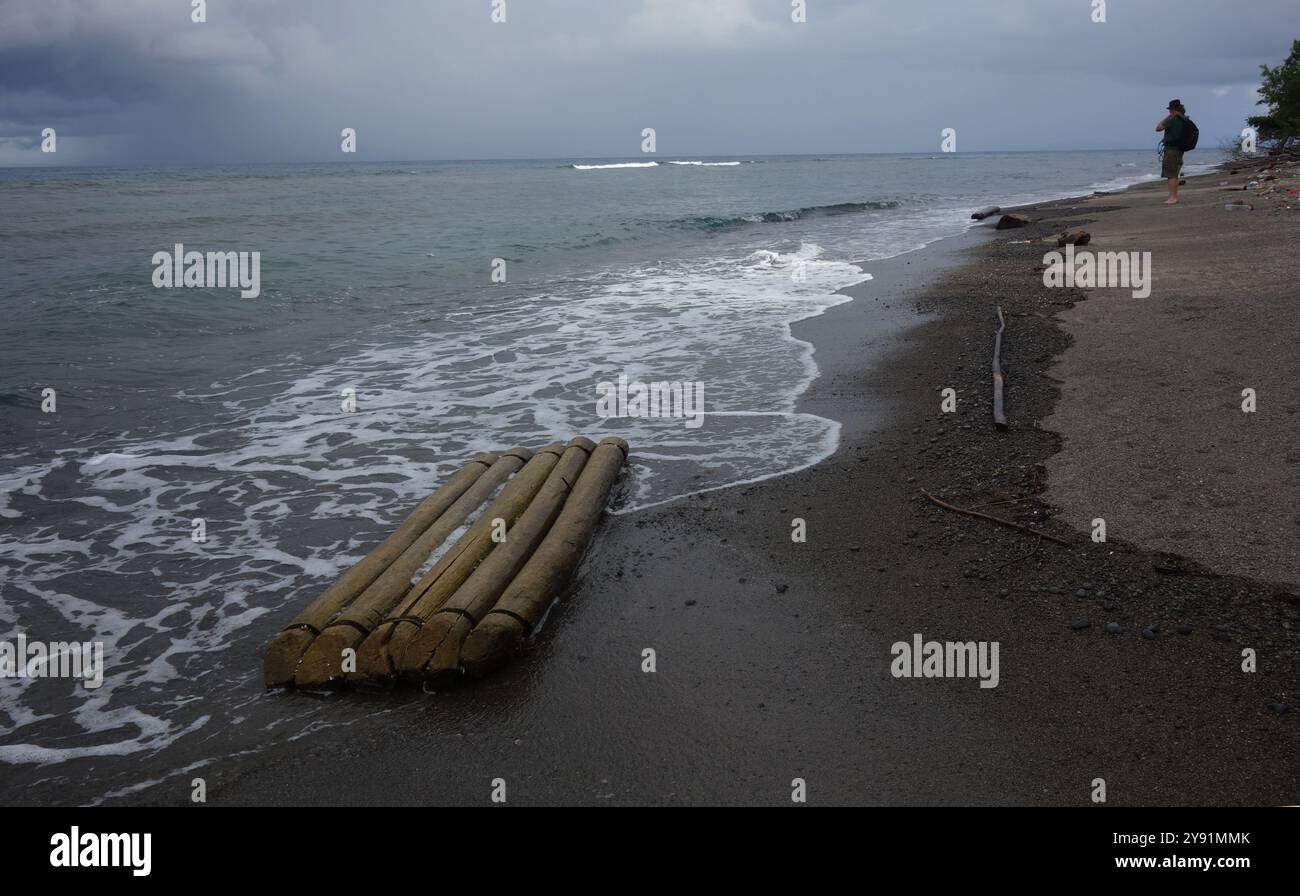 Storm coming towards beach with makeshift raft, Una Una Island, Togean ...