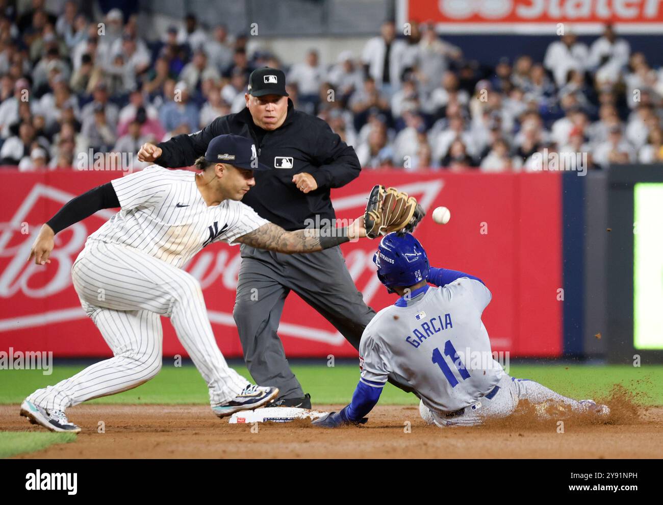 Kansas City Royals Maikel Garcia safely steals second under a tag by New York Yankees second ...