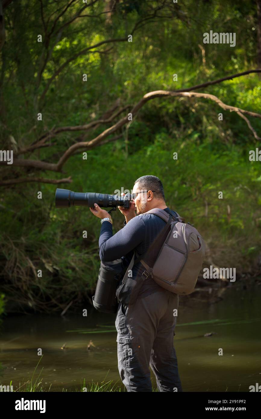 Bird watching - a male hiker taking photos of birds in Organ Pipes ...